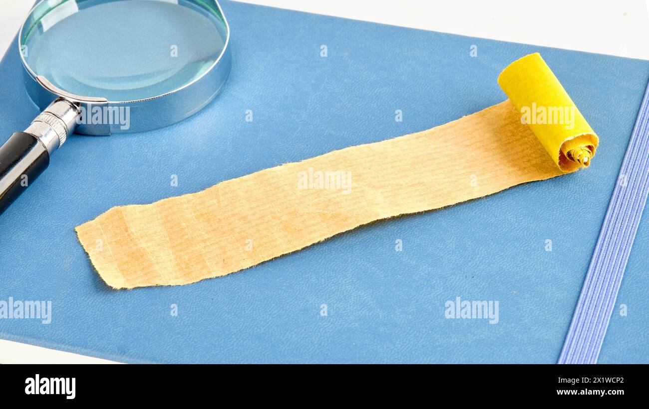 A piece of paper, crumpled paper, an unfolded sheet of paper on a blue ...
