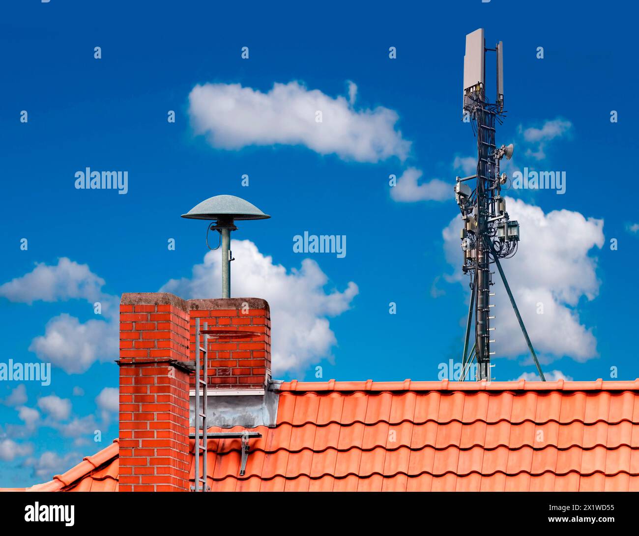 Alarm siren and radio mast on one roof Stock Photo - Alamy