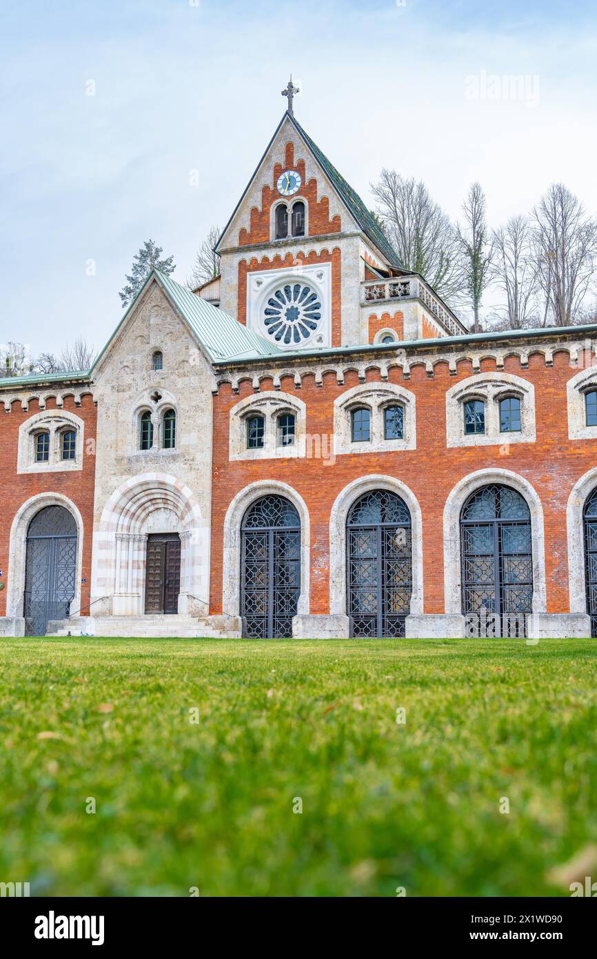 Historic church with Gothic style and brick facade under a cloudy sky ...