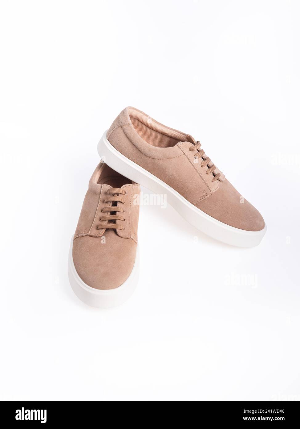 Beige women's sneakers, white background, top view Stock Photo - Alamy