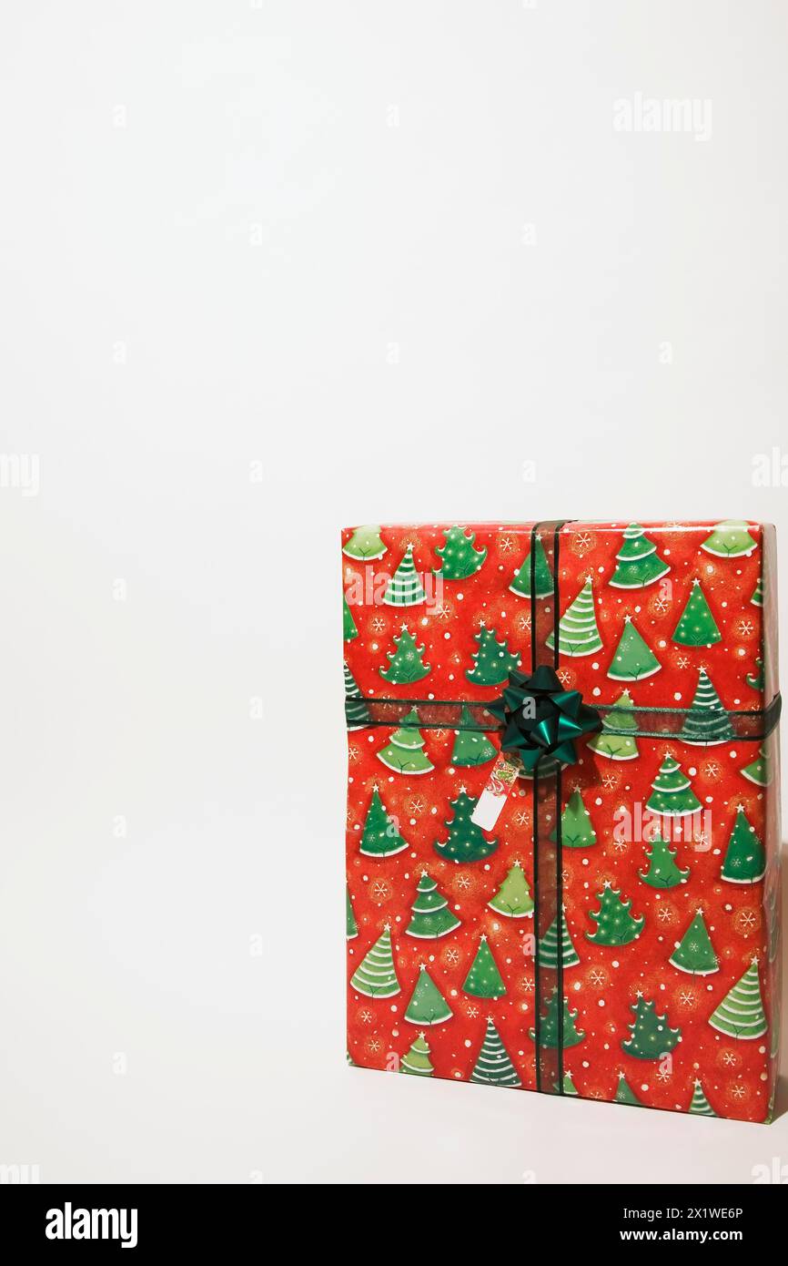 Close-up of box shaped Christmas gift wrapped with red and green ...