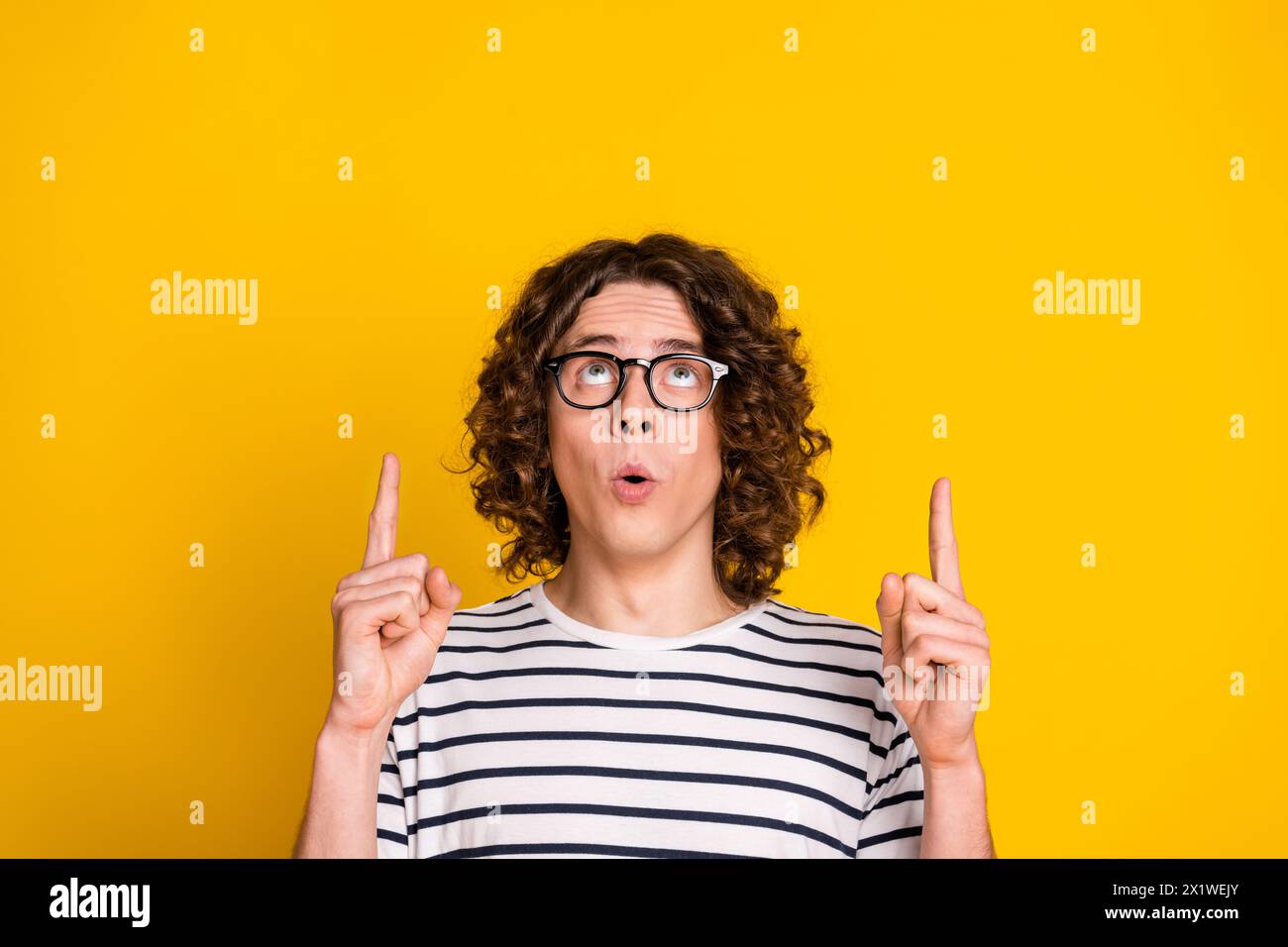 Close up photo of young amazed funny nerd guy direct fingers above head ...