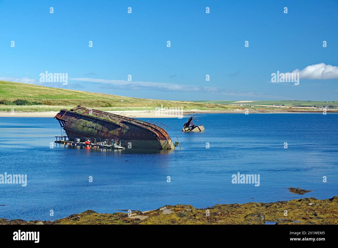 Parts of sunken ships sticking out of the water, Churchill Barriers ...