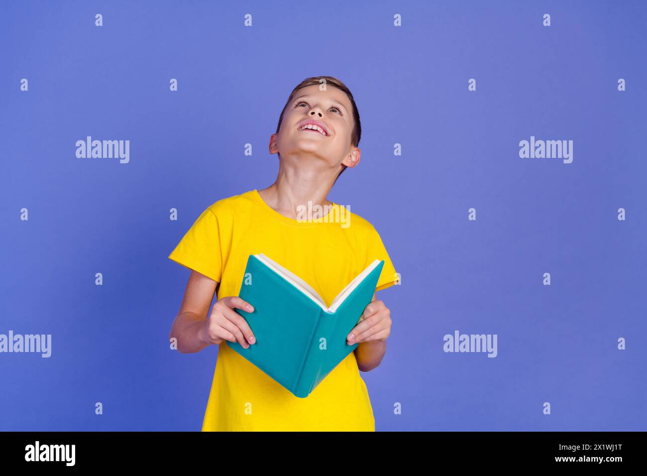 Photo of smart cute little boy nerd wear stylish yellow clothes hold ...