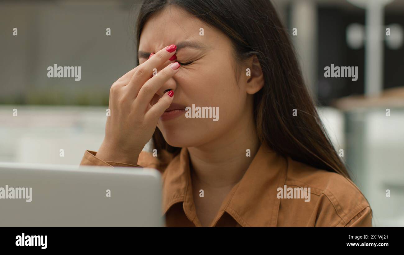 Overworked Asian woman girl working laptop in cafe suffer eyestrain ...