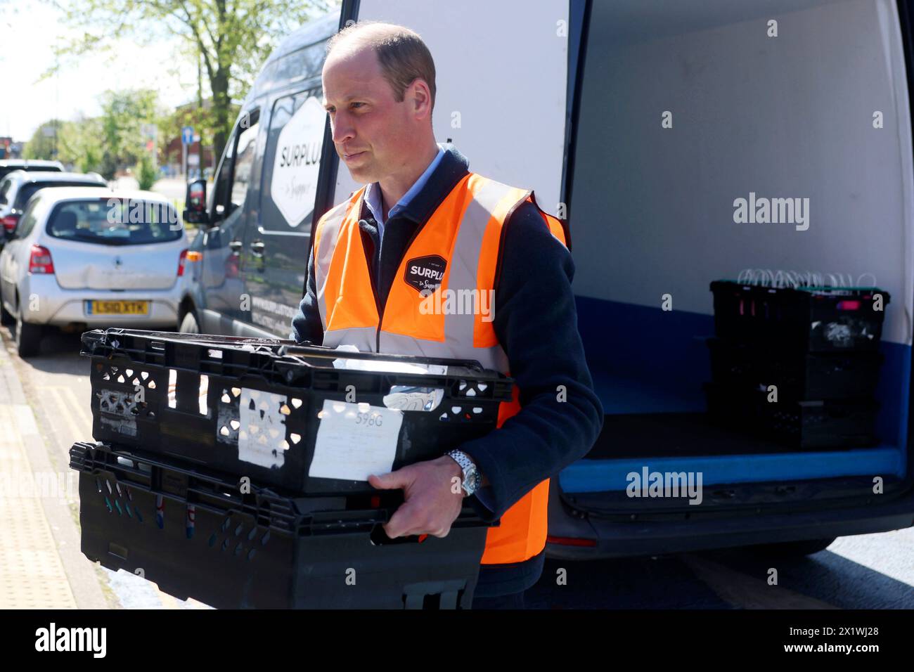 Britain's Prince William, center, helps to unload a van as he visits ...