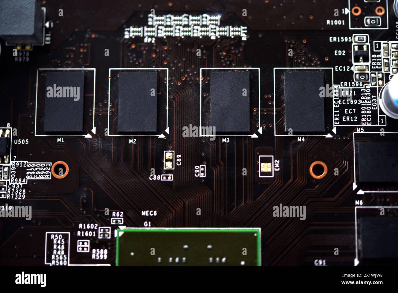 A brown printed circuit board with a processor chip and video memory ...