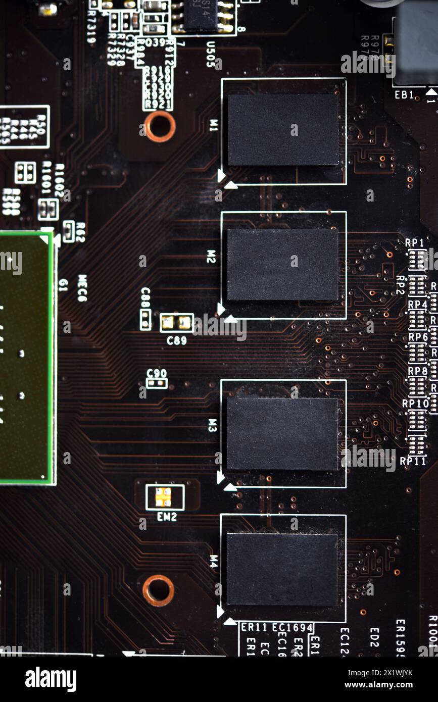 A brown printed circuit board with a processor chip and video memory ...