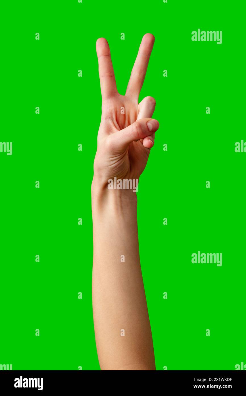 Hand Making Peace Sign Gesture Against Vibrant Green Background Stock ...