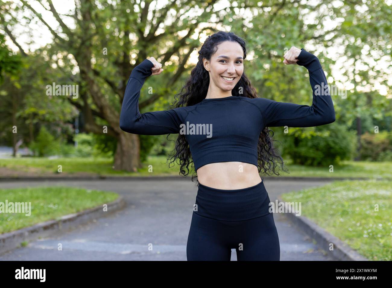 Woman flexes confidently in green hi-res stock photography and images ...