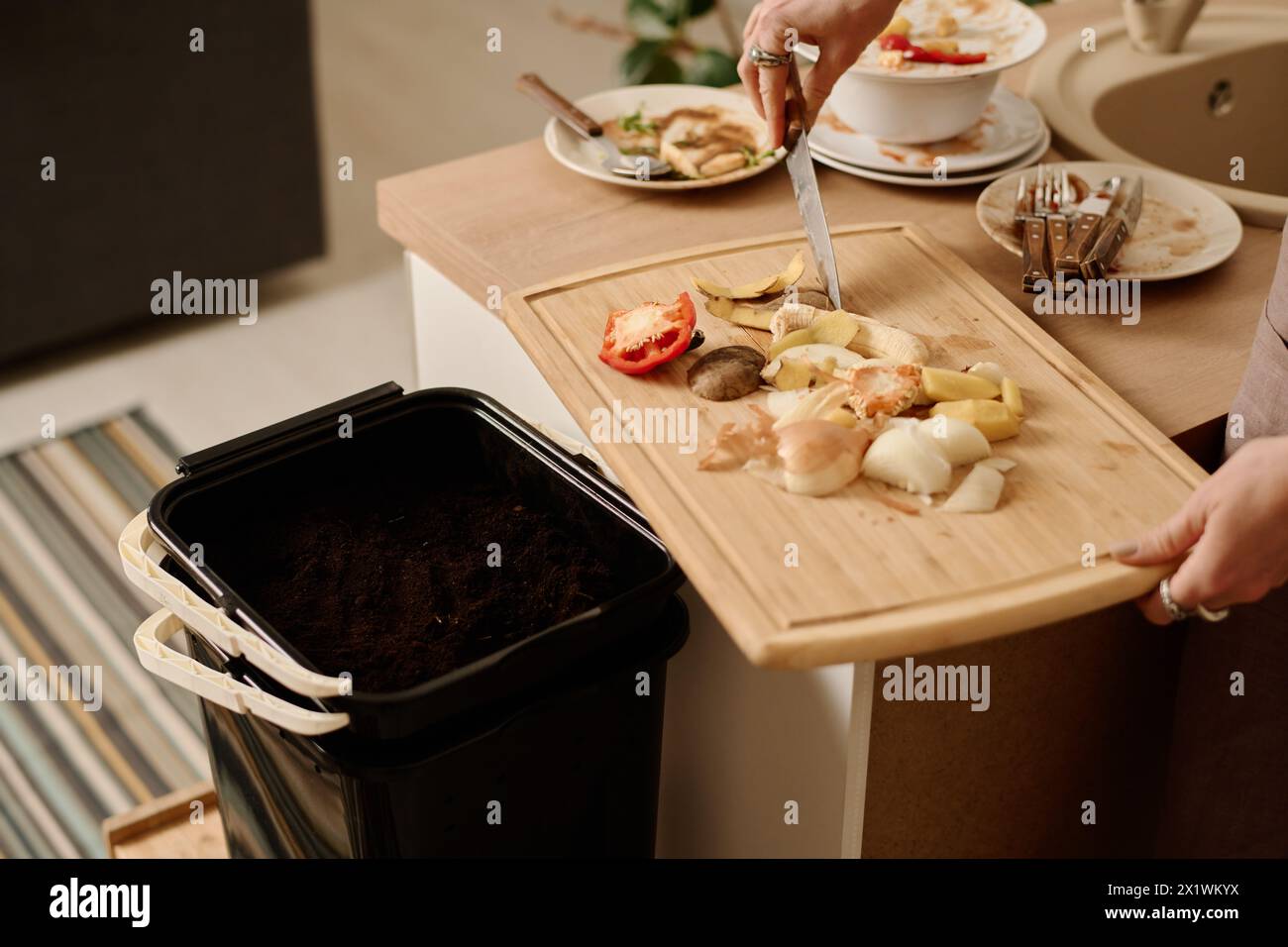 Hands of young unrecognizable woman with wooden chopping board and ...