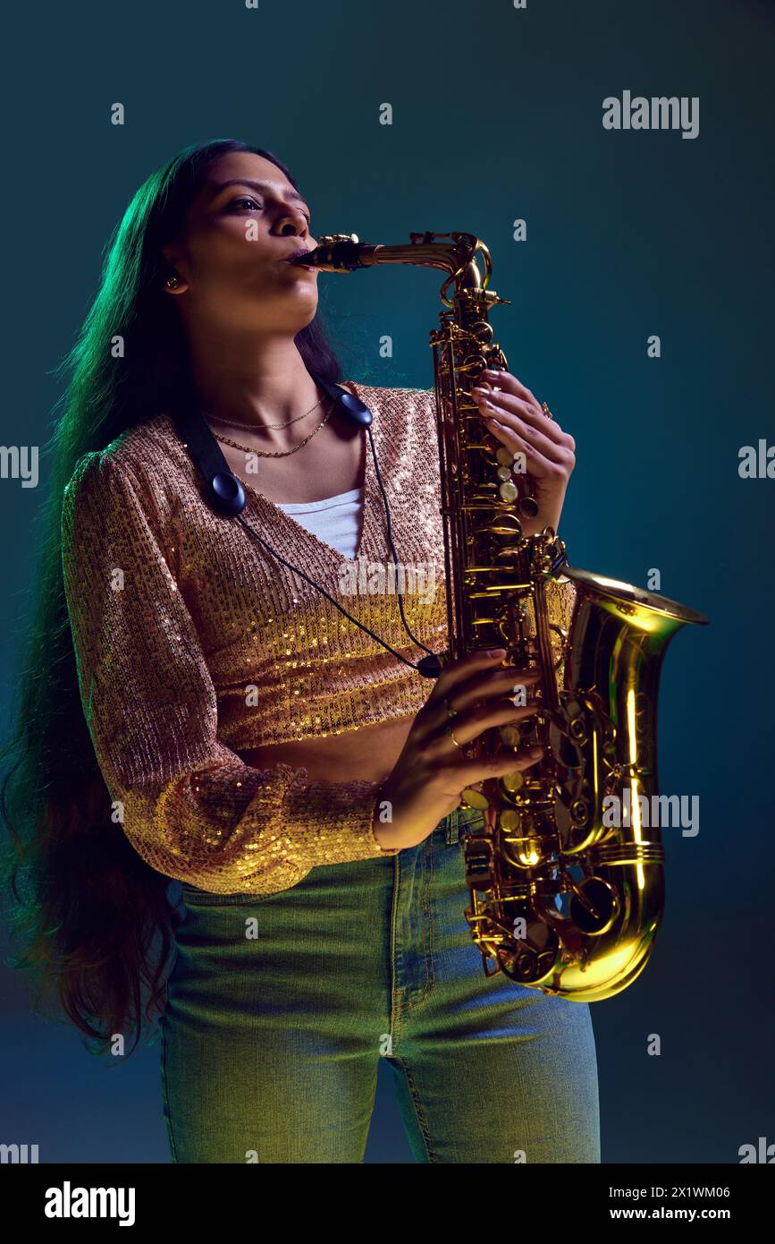 Intense Indian female musician with sax, wearing shiny apparel ...