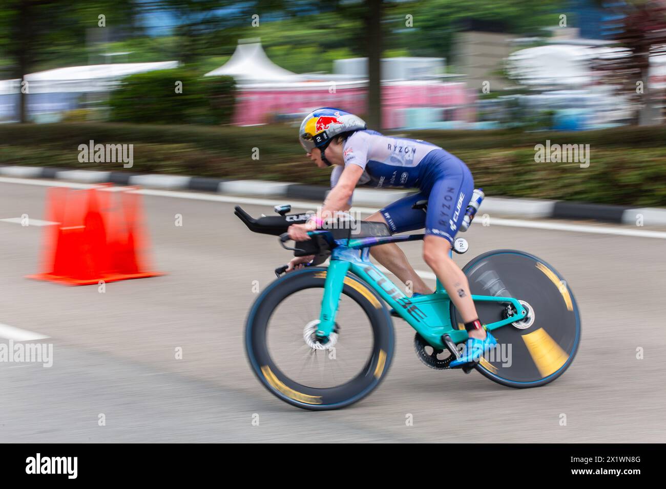 13 April 2024. Panning view of Female elite athletic on pro bicycle ...