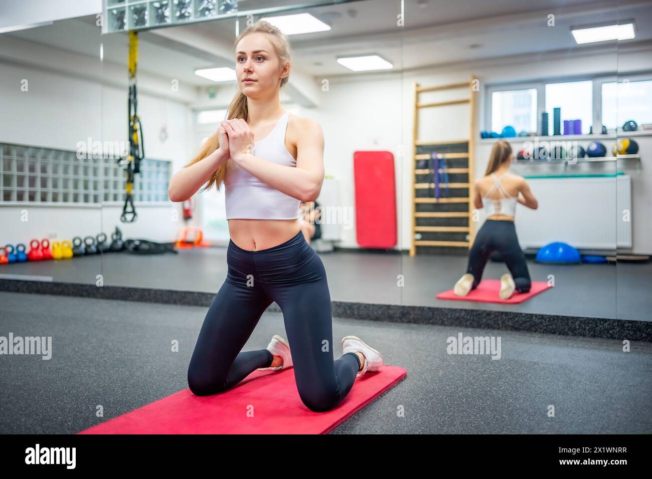 Young woman works out in the gym performing an exercise Stock Photo - Alamy