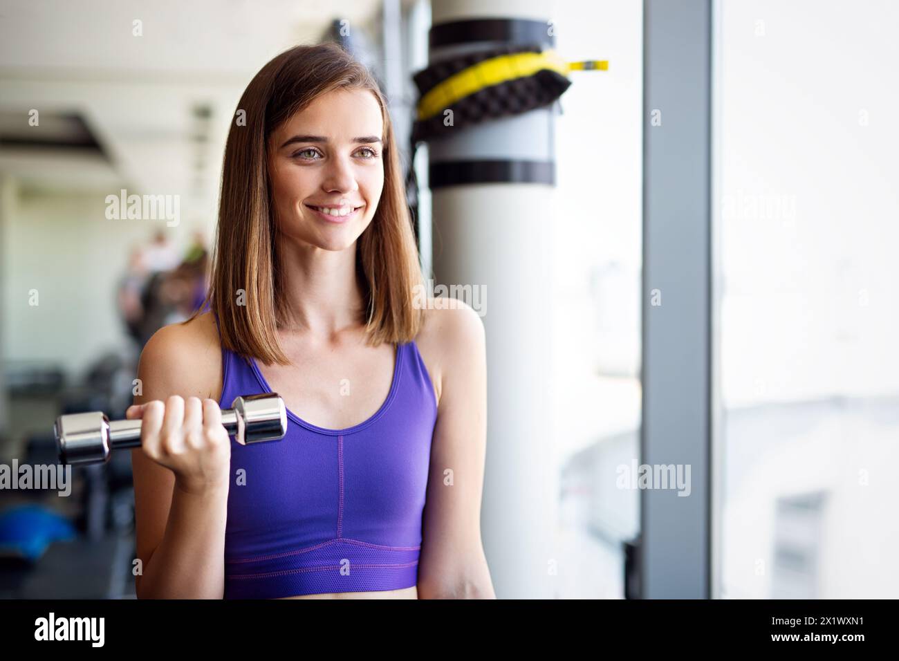 Fitness woman. Fit fitness girl smiling happy lifting weights looking ...