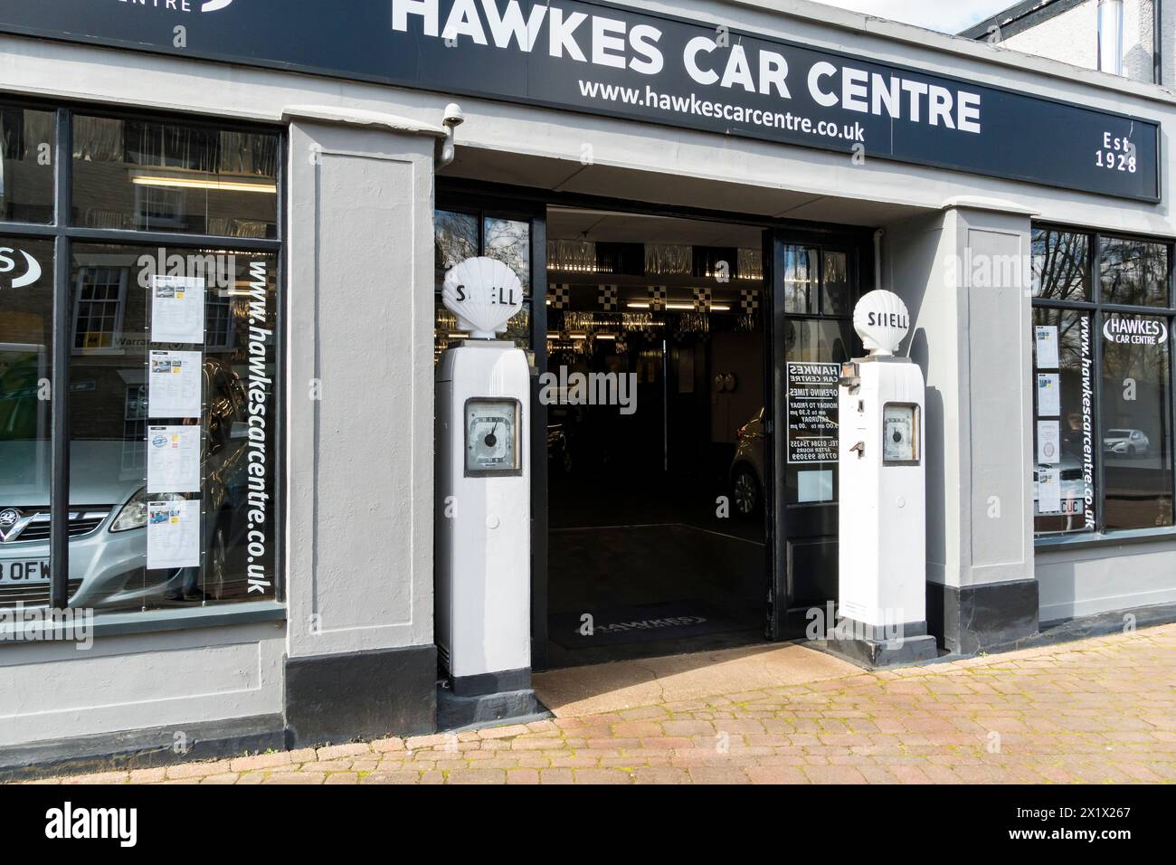 Old Shell petrol pumps at car dealer entrance Stock Photo - Alamy