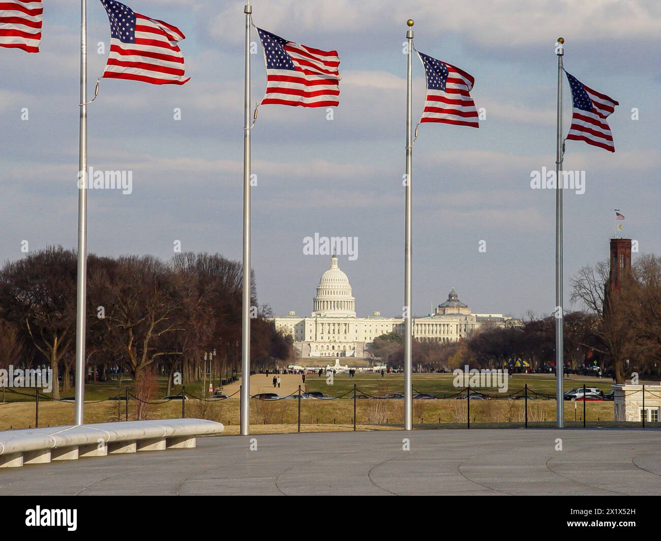 US Capitol building between flying flags Stock Photo - Alamy