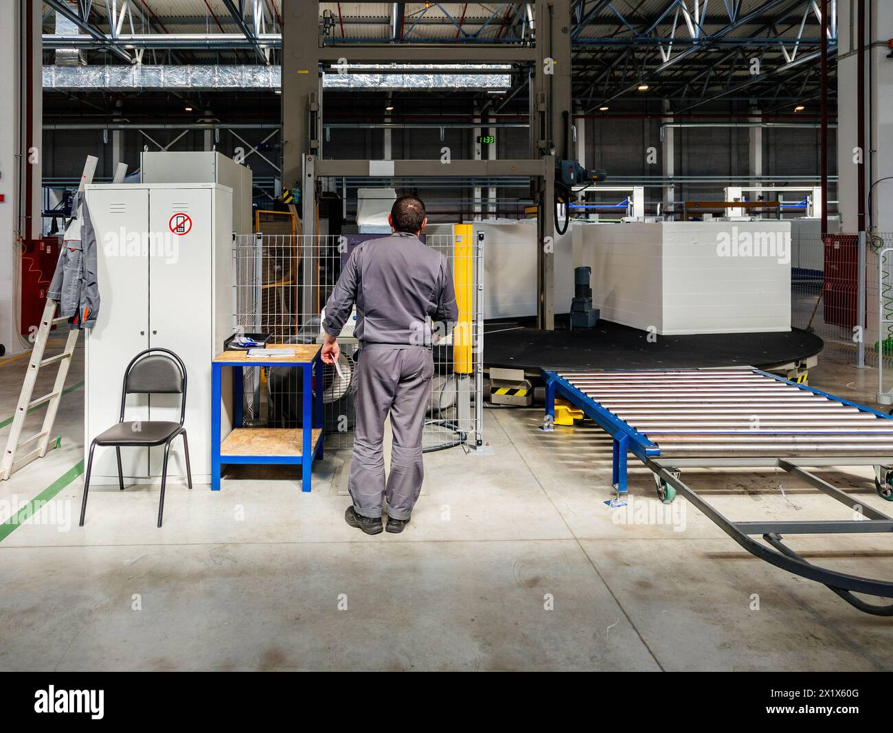 Workers at foam rubber blocks cutting machine Stock Photo - Alamy