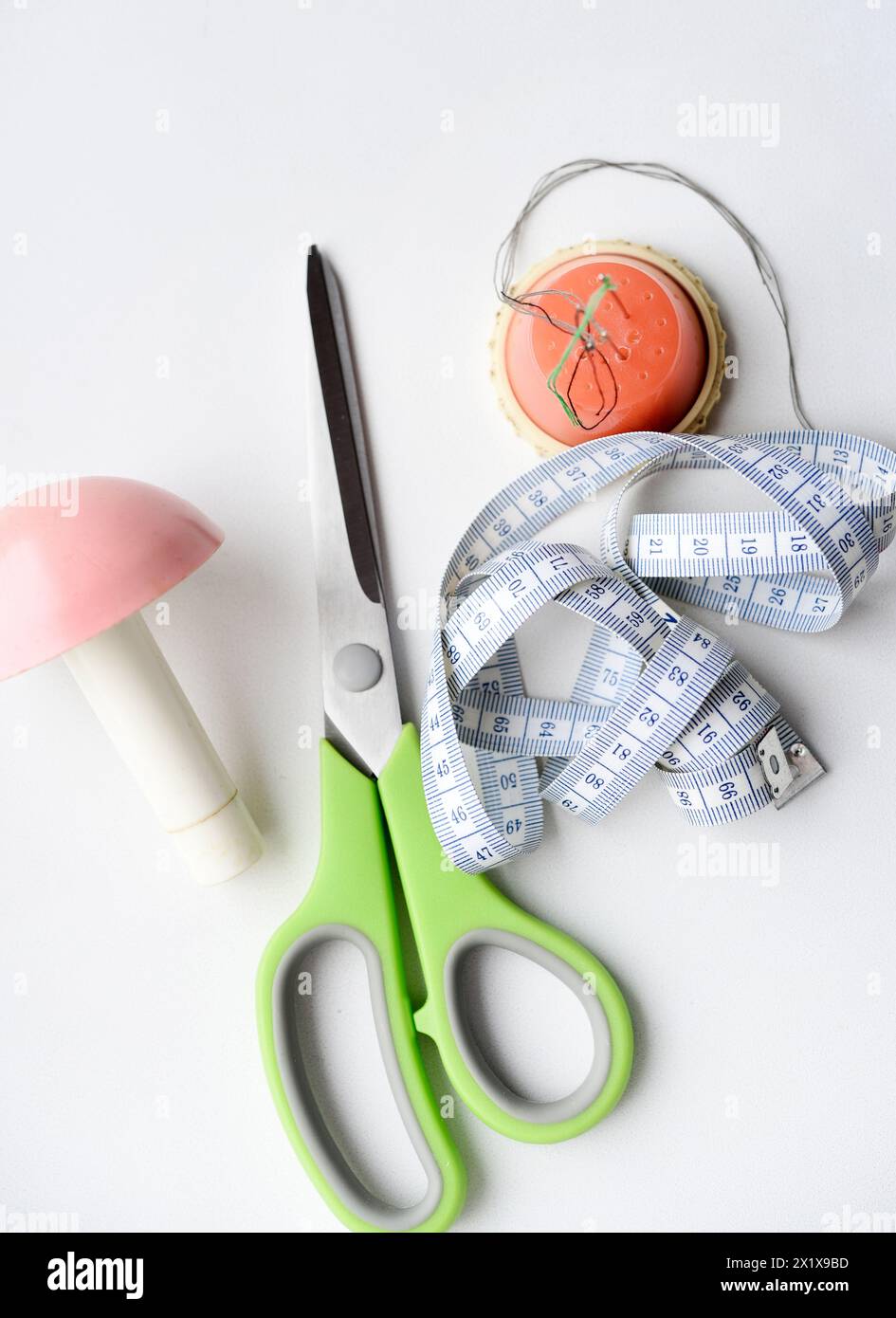Sewing scissors, measuring tape and thread with a needle. Sewing kit ...