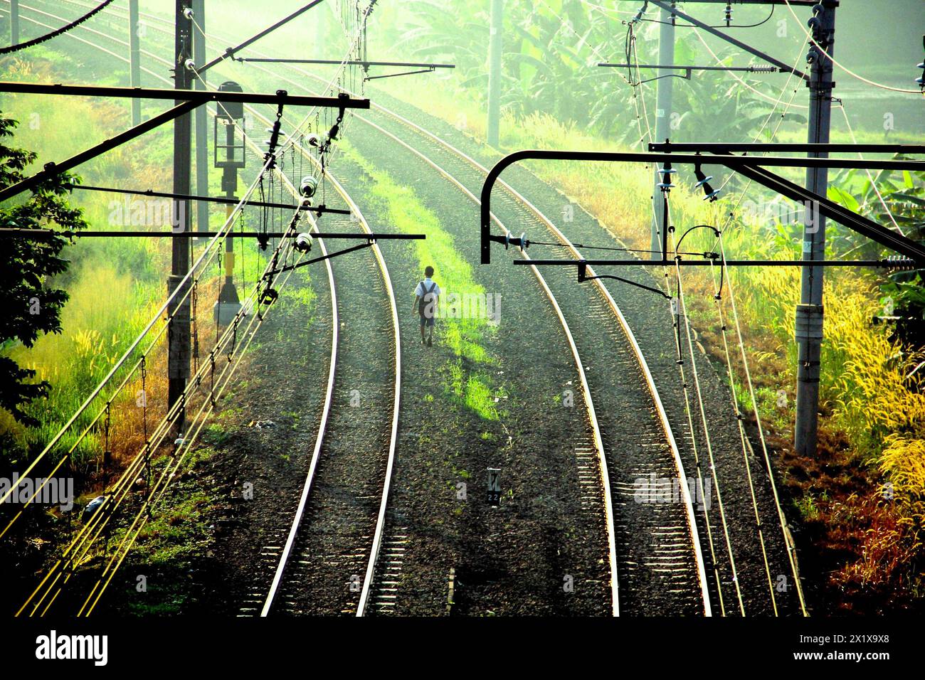 walking alone alongside empty railway Stock Photo - Alamy