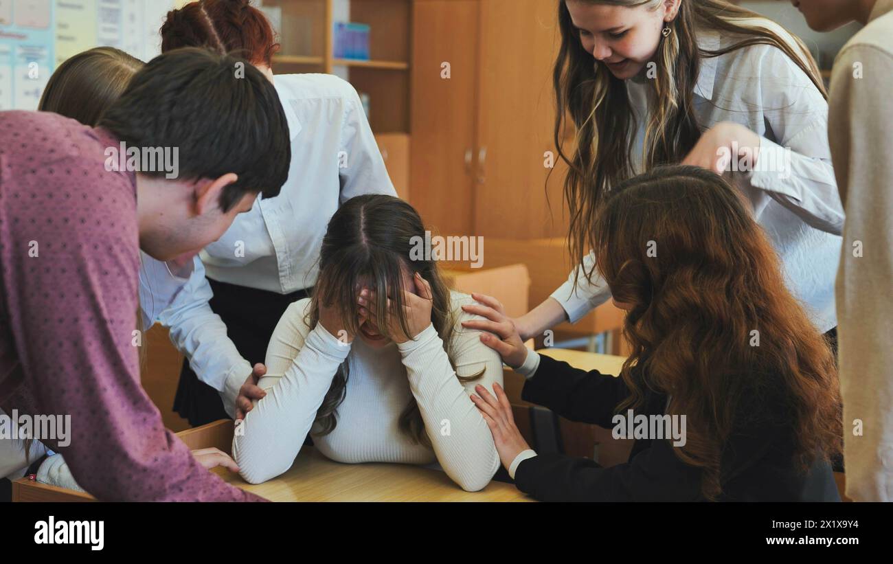 A high school girl cries and her friends comfort her Stock Photo - Alamy