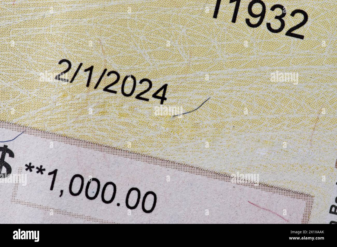 Close up of check in the amount of $1000 Stock Photo - Alamy
