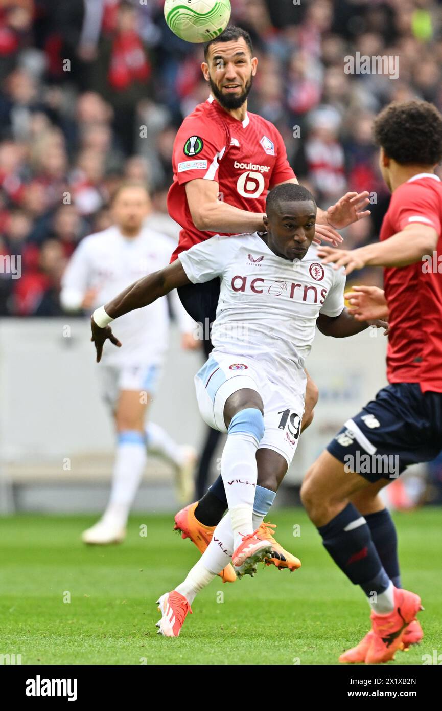 Lille, France. 18th Apr, 2024. Moussa Diaby (19) of Aston Villa fighting for the ball with Nabil ...