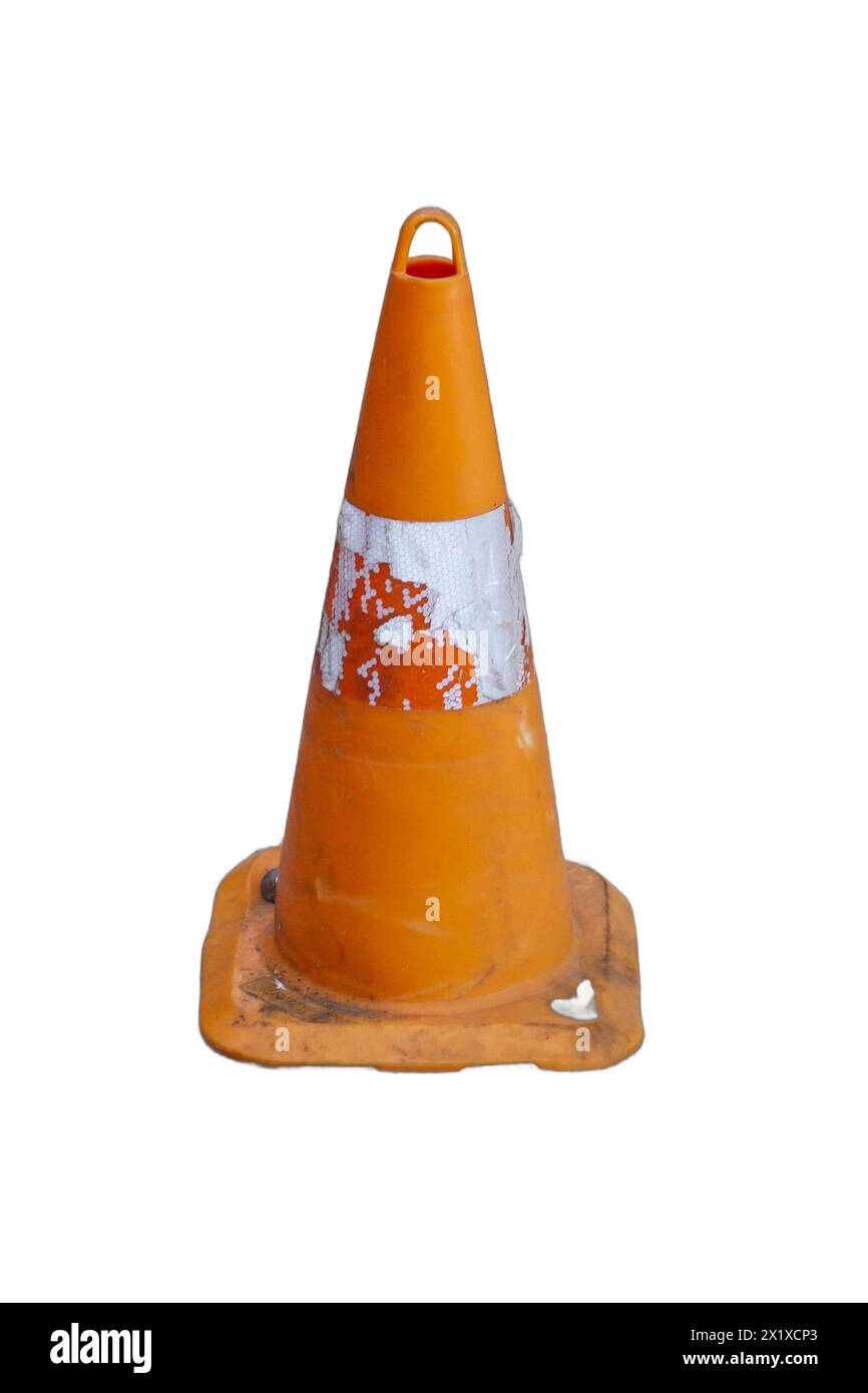 An isolated, battered traffic cone, showing signs of wear and tear ...