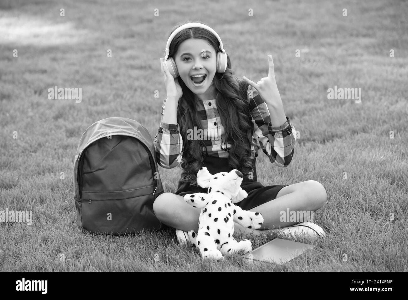 Happy teen girl showing horn sign after school, music. back to school ...