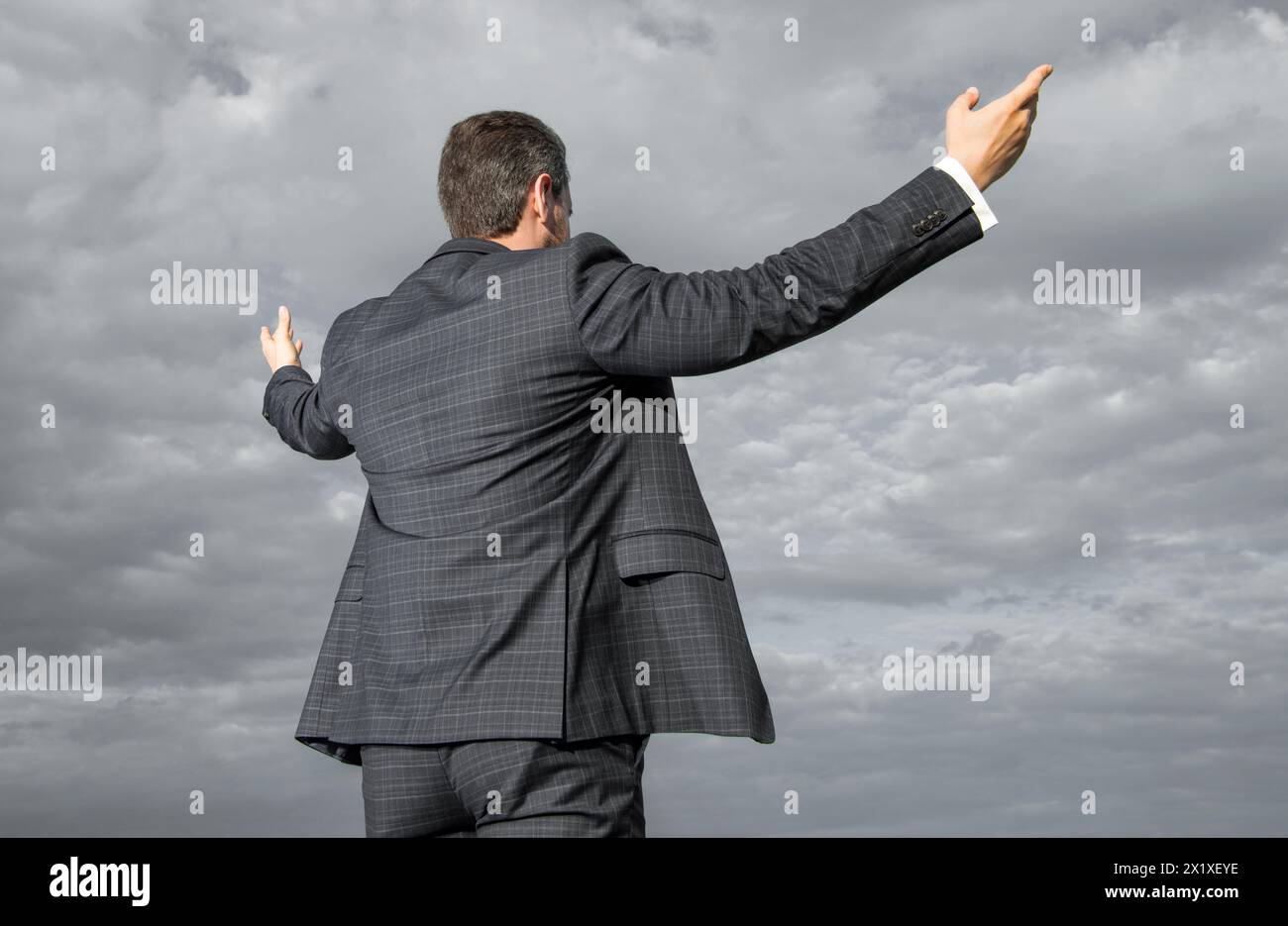 Professional man back view sky background. Man spreading arms wide open ...