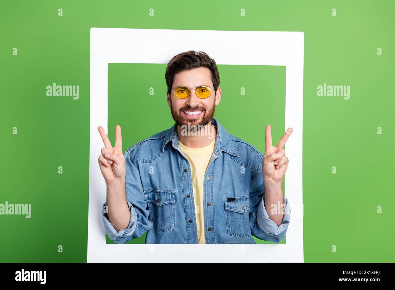 Photo of cheerful friendly guy wear denim jacket tacking photo showing ...