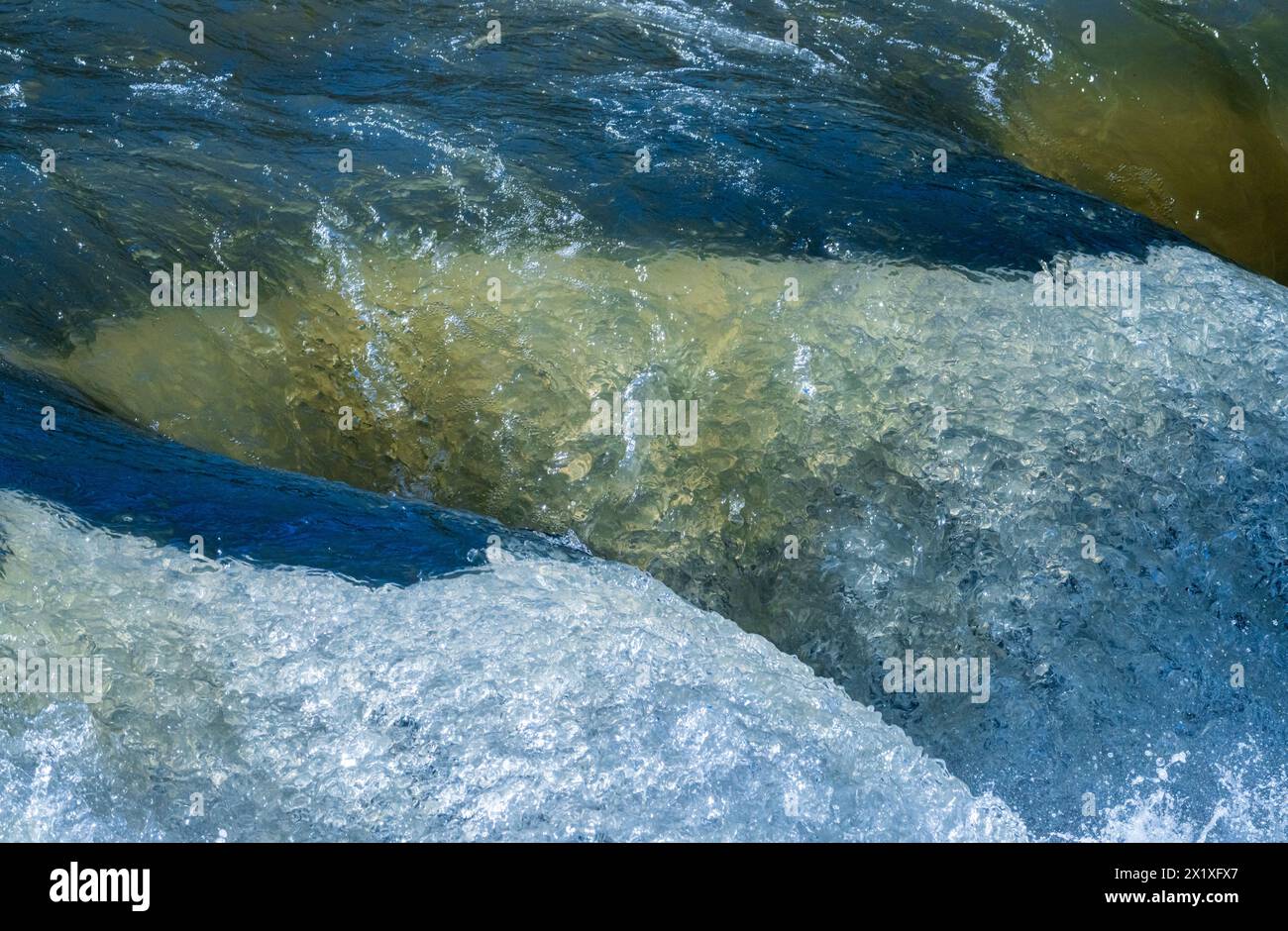 Frozen motion view of raging water flowing over rocks of Valley Falls ...