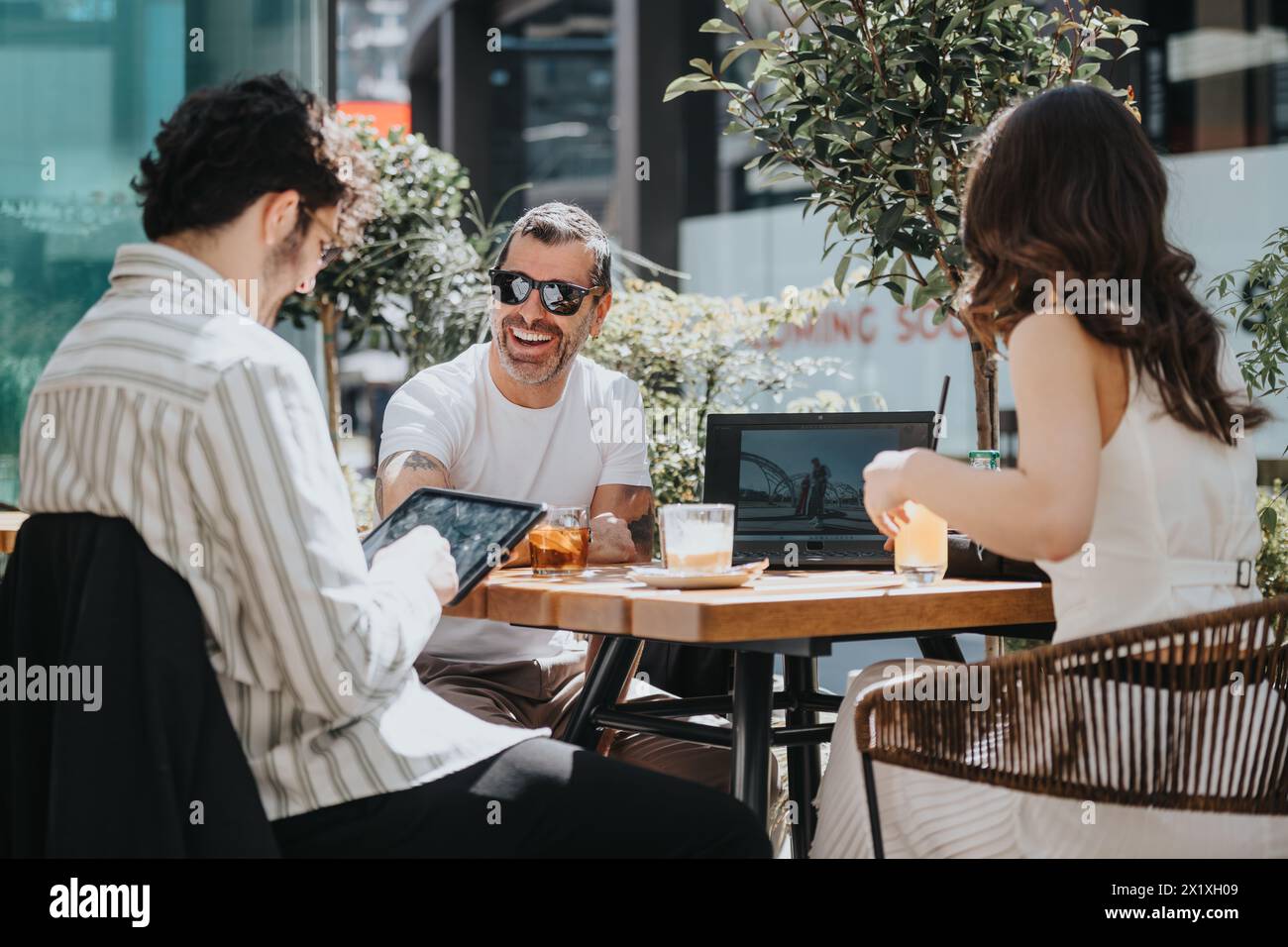 Multi generational entrepreneurs strategizing at a coffee bar with ...