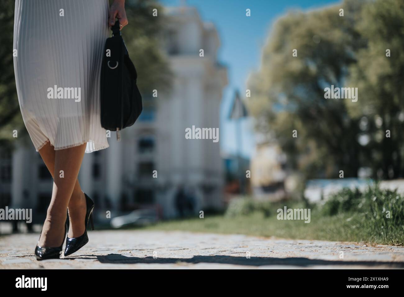 Elegant woman walking in the city - close-up on legs and high heels ...