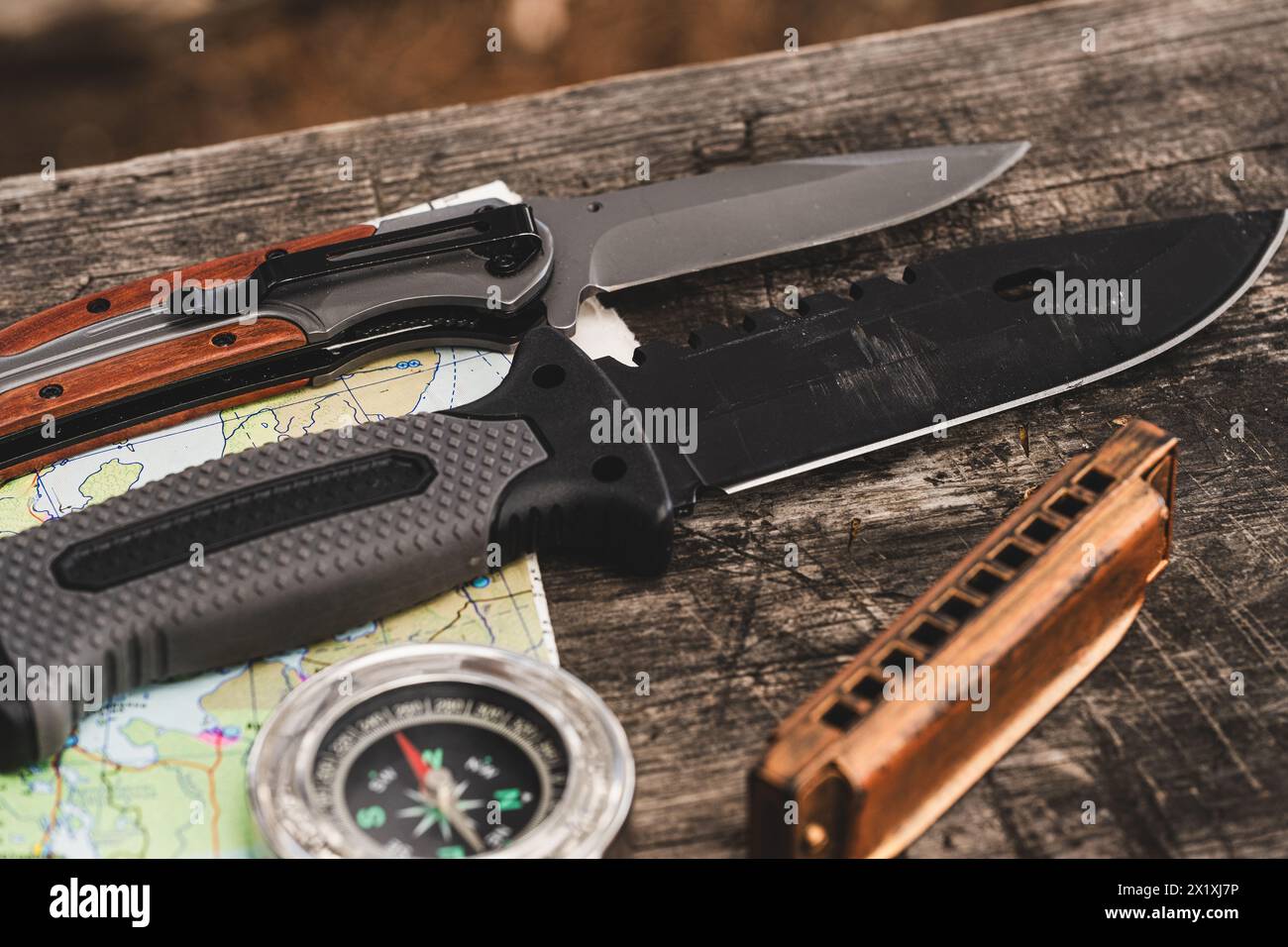 Ready for the journey, knife, compass, harmonica, map set on wooden ...