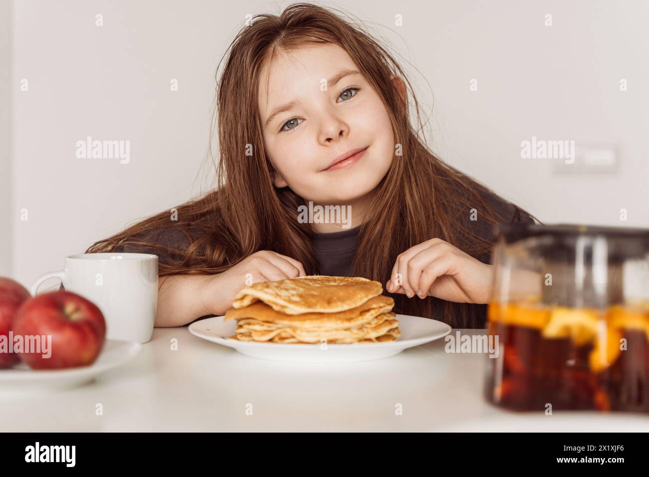 Happy morning. Breakfast of a happy child. Little pre-teen girl with a ...