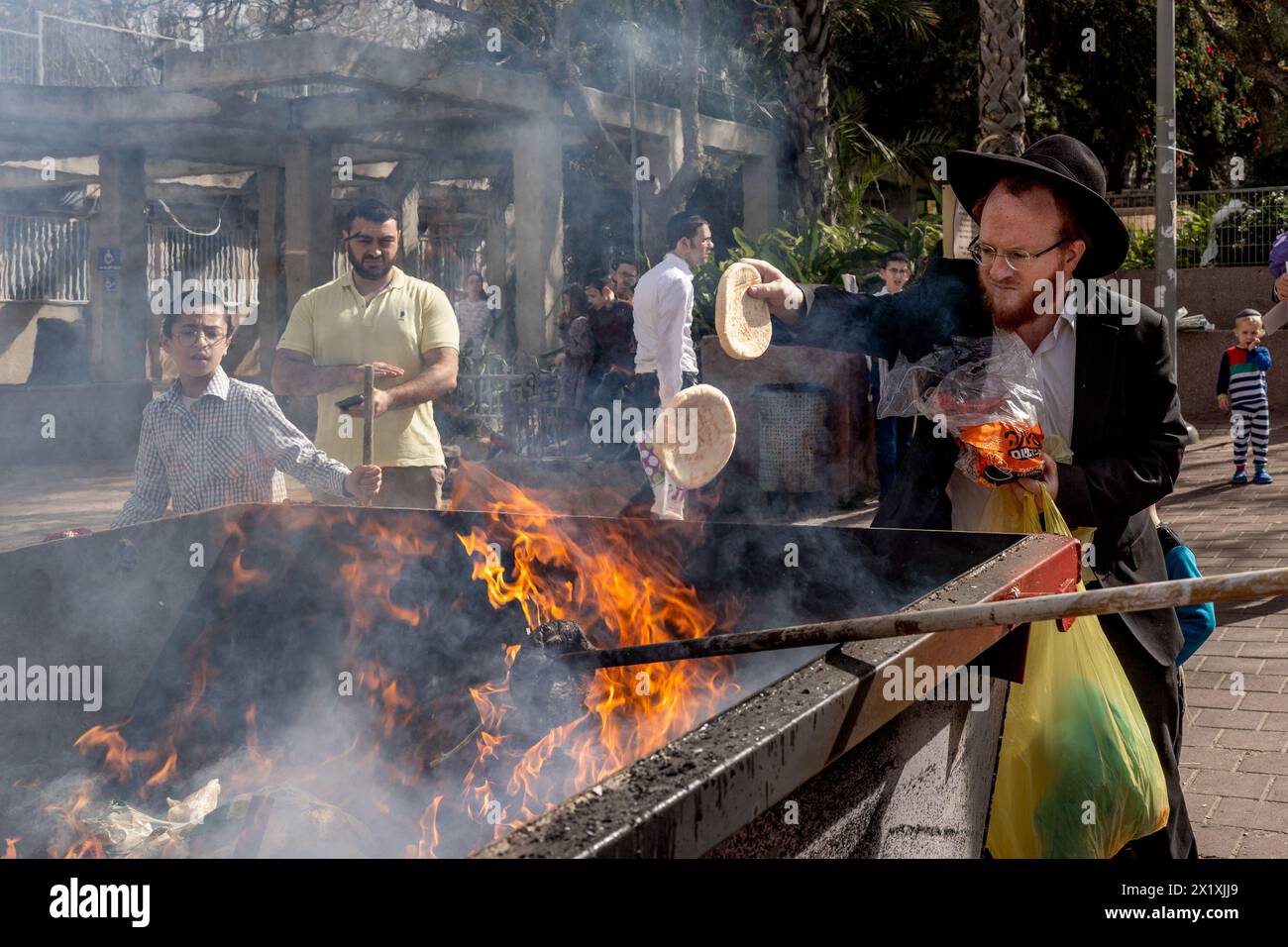 A Jewish man seen throwing leaven into the fire before the Passover ...