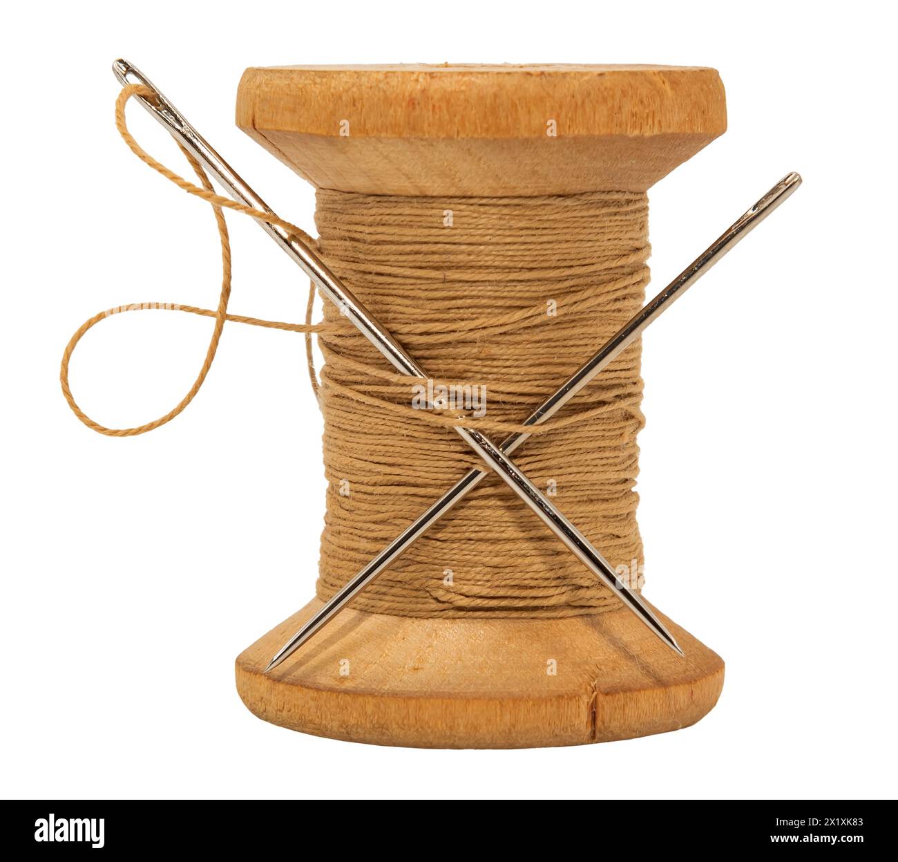 Old wooden spool of thread and needle on a white background. Sewing ...