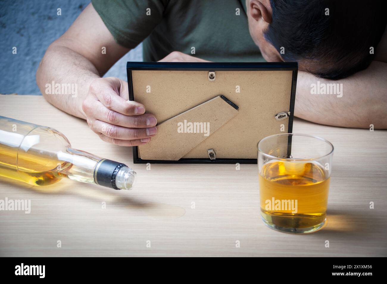 Sad drunk husband who misses his wife after divorce with a photo of the ...