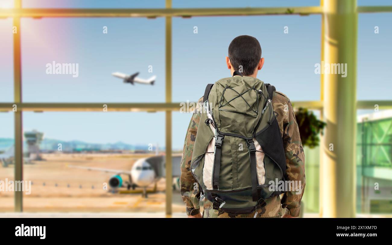 Shot of a soldier in a military uniform looking through the window at ...
