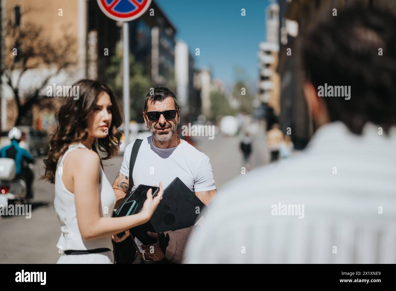 Cross-generational business executives discussing strategy outdoors in ...