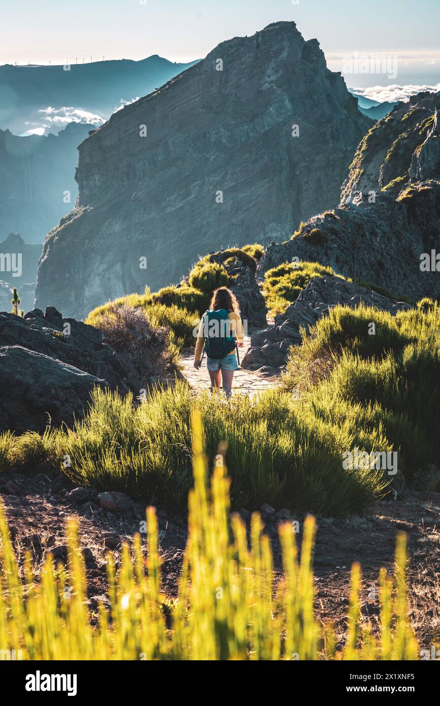 Description: Female tourist walks along a panoramic hiking trail and ...