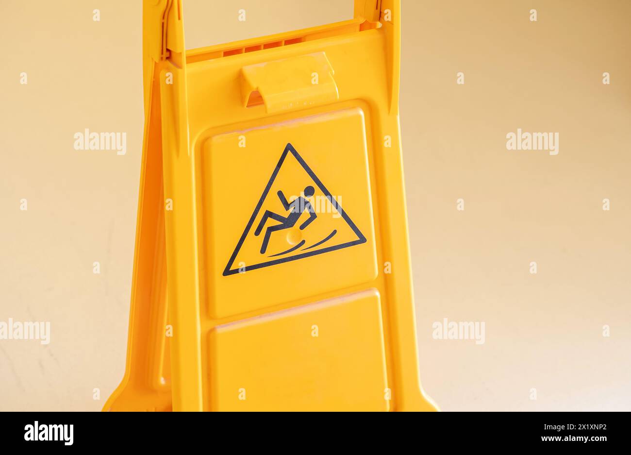 Bright orange wet floor sign is alerting warning of the potential ...