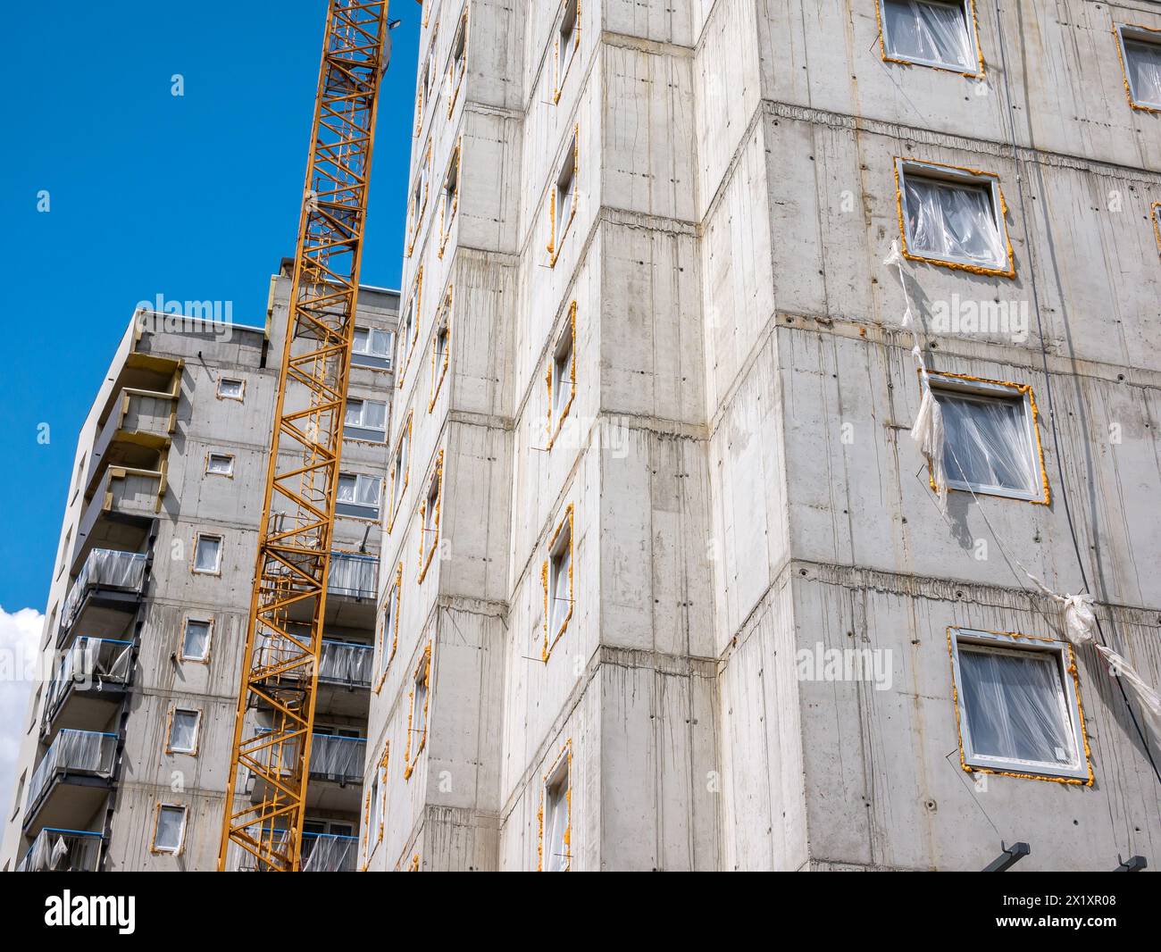 Multi-story residential block under construction, with exposed concrete ...