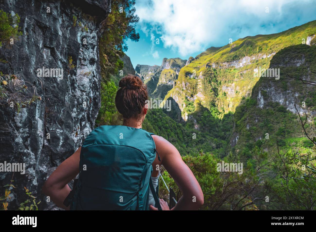 Description: Female backpacker toursit enjoys scenic view from below ...