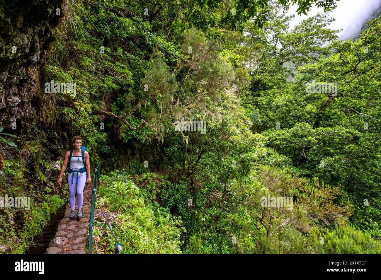 Description: Backpacker tourist walks along picturesque hike trail ...