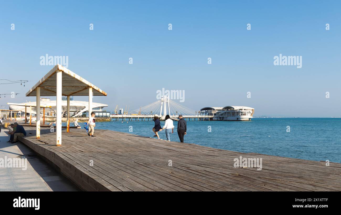 Photo of the Durres promenade with a family walking by the seaside ...