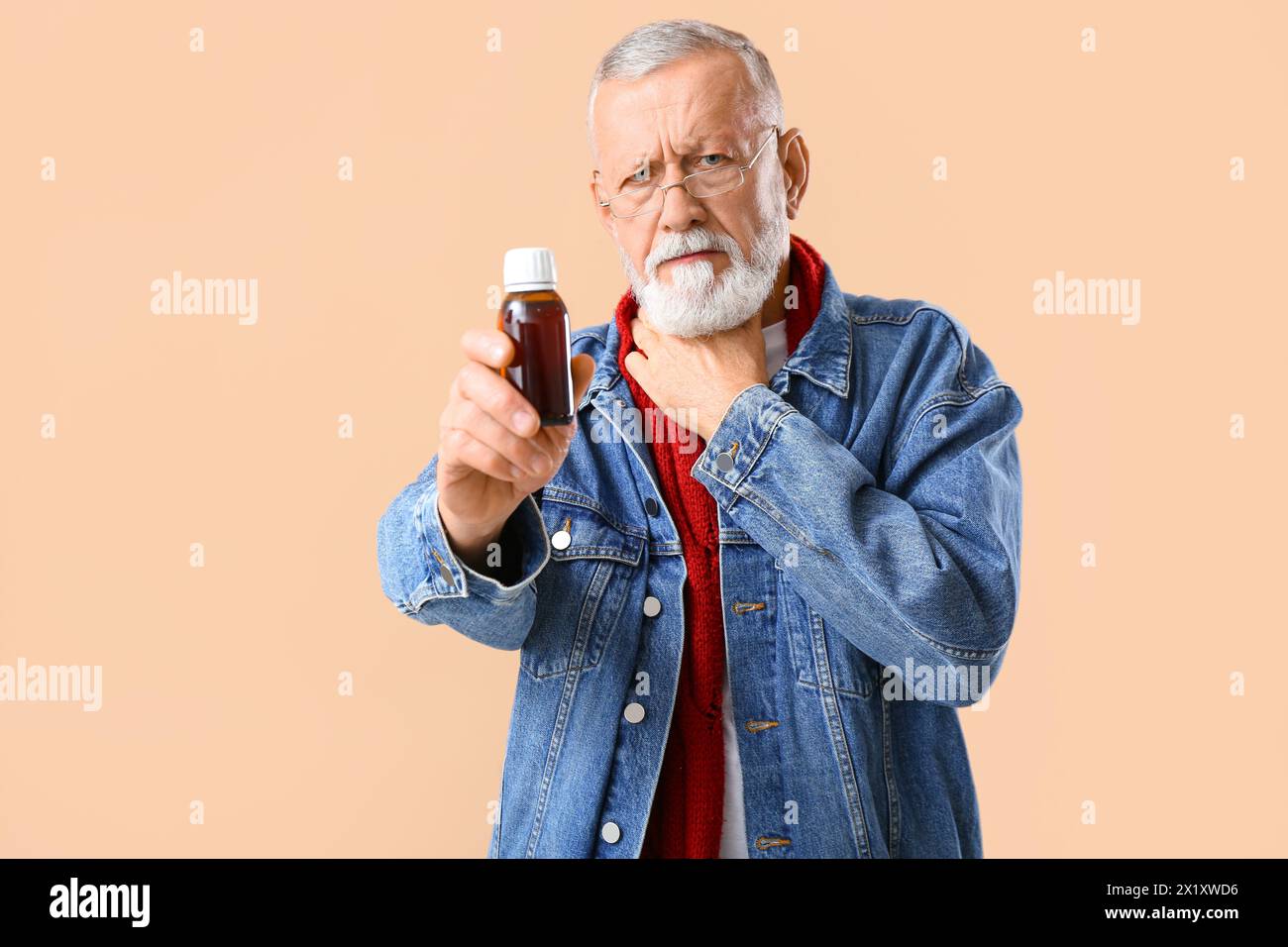 Old man with sore throat holding cough syrup on beige background Stock ...