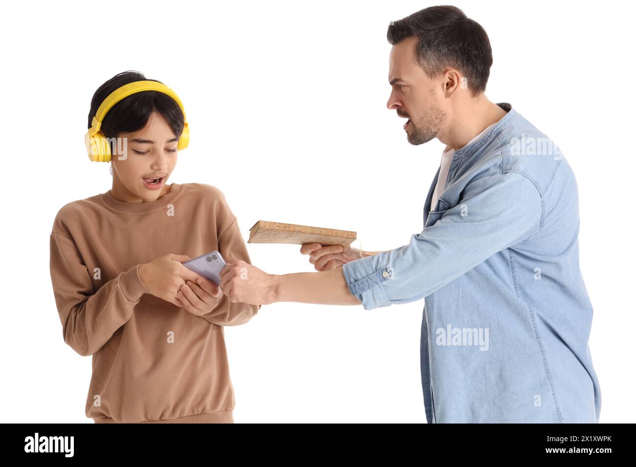 Angry father with book taking mobile phone away from his teenage son on ...