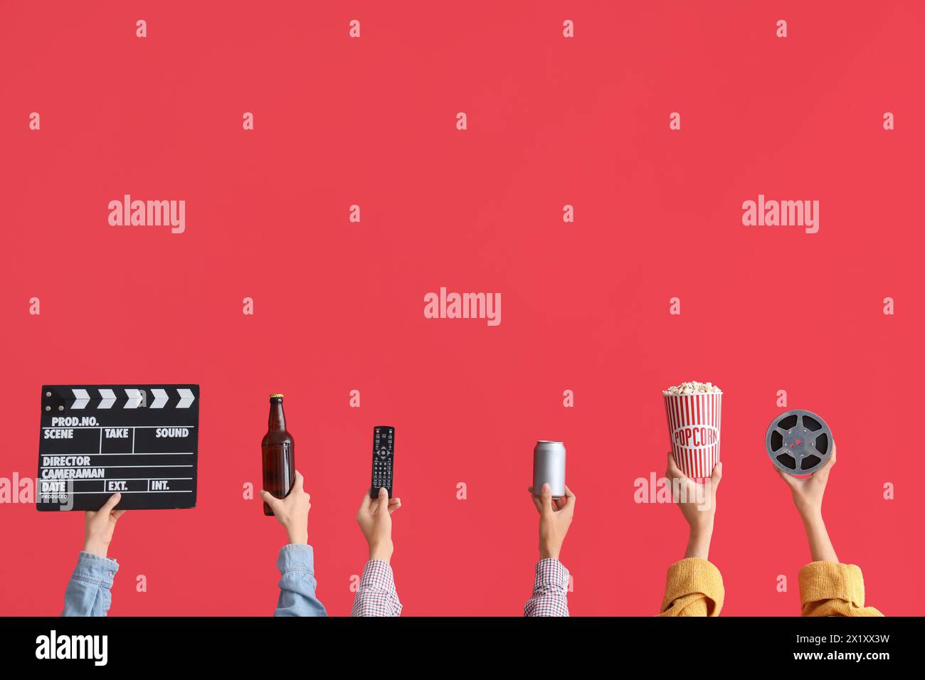 Many hands with bucket of popcorn, movie clapper and beer on red ...